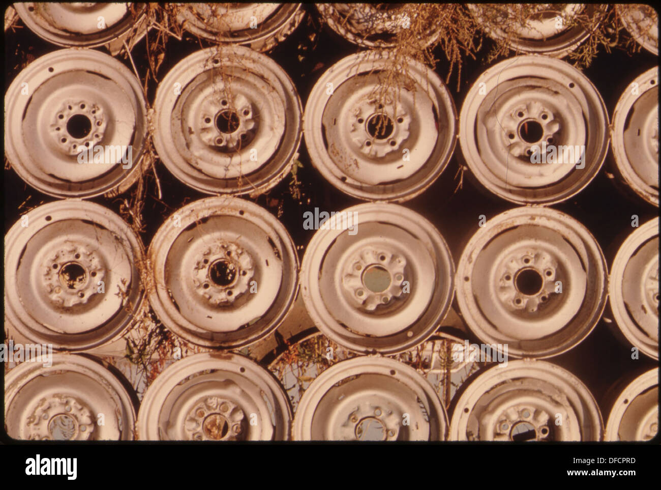A close-up view of a fence constructed using tire rims in New Ulm ...