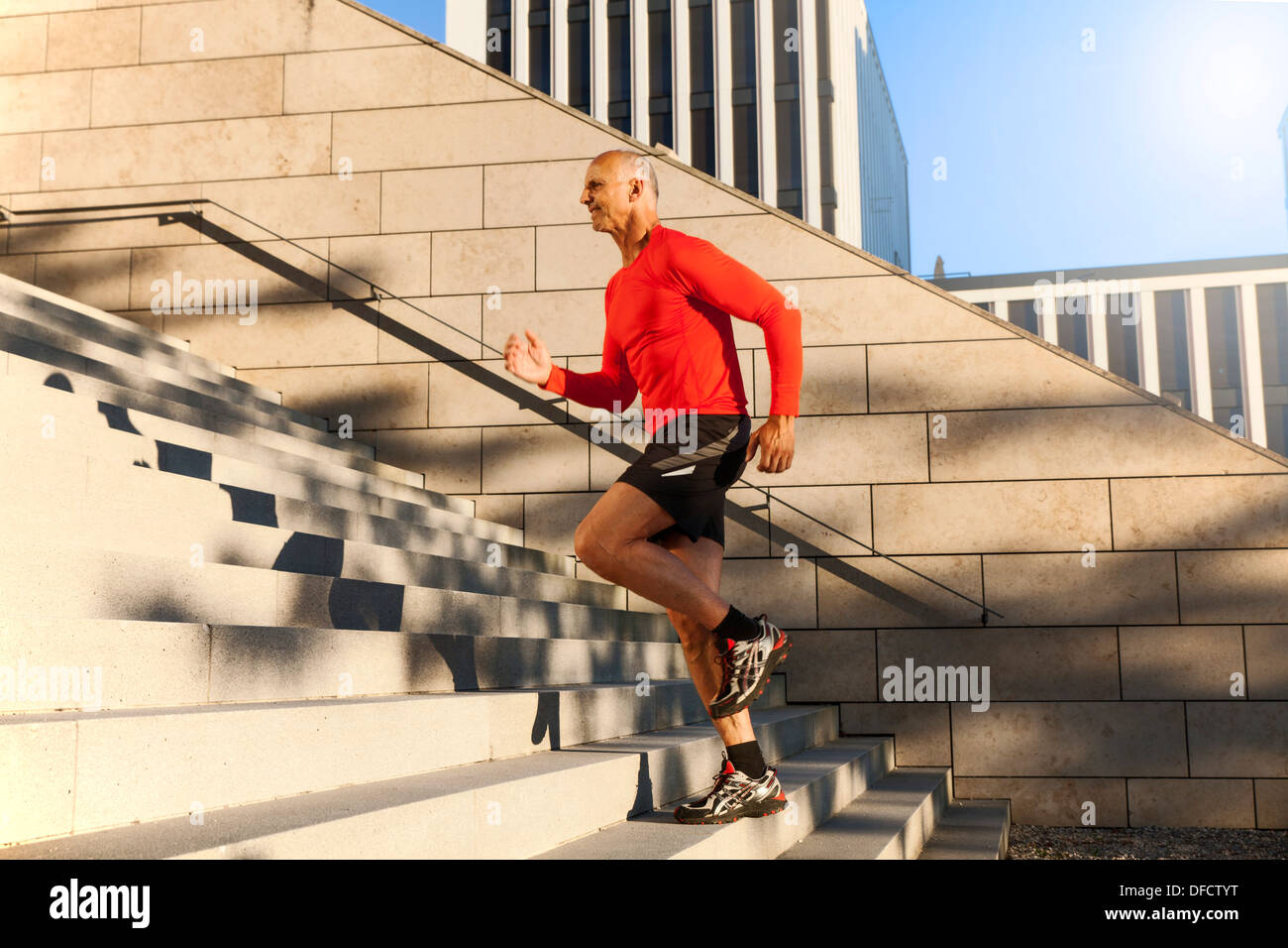 Mature athletic man running upstairs Stock Photo - Alamy