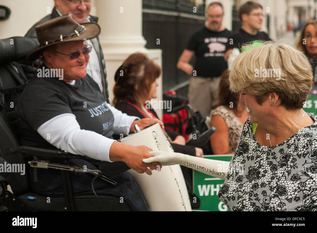 London, UK. 2nd October 2013. Thalidomide victim hold real hand to fake ...