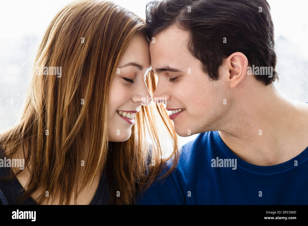 Germany, Bavaria, Munich, Young couple falling in love, smiling Stock ...