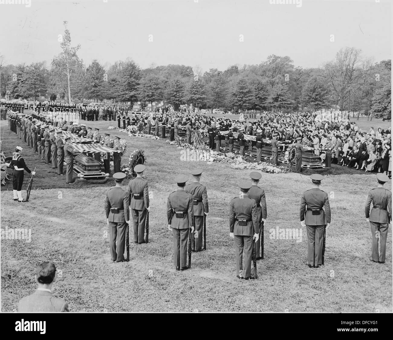 President Harry S. Truman is shown attending the burial of twenty ...