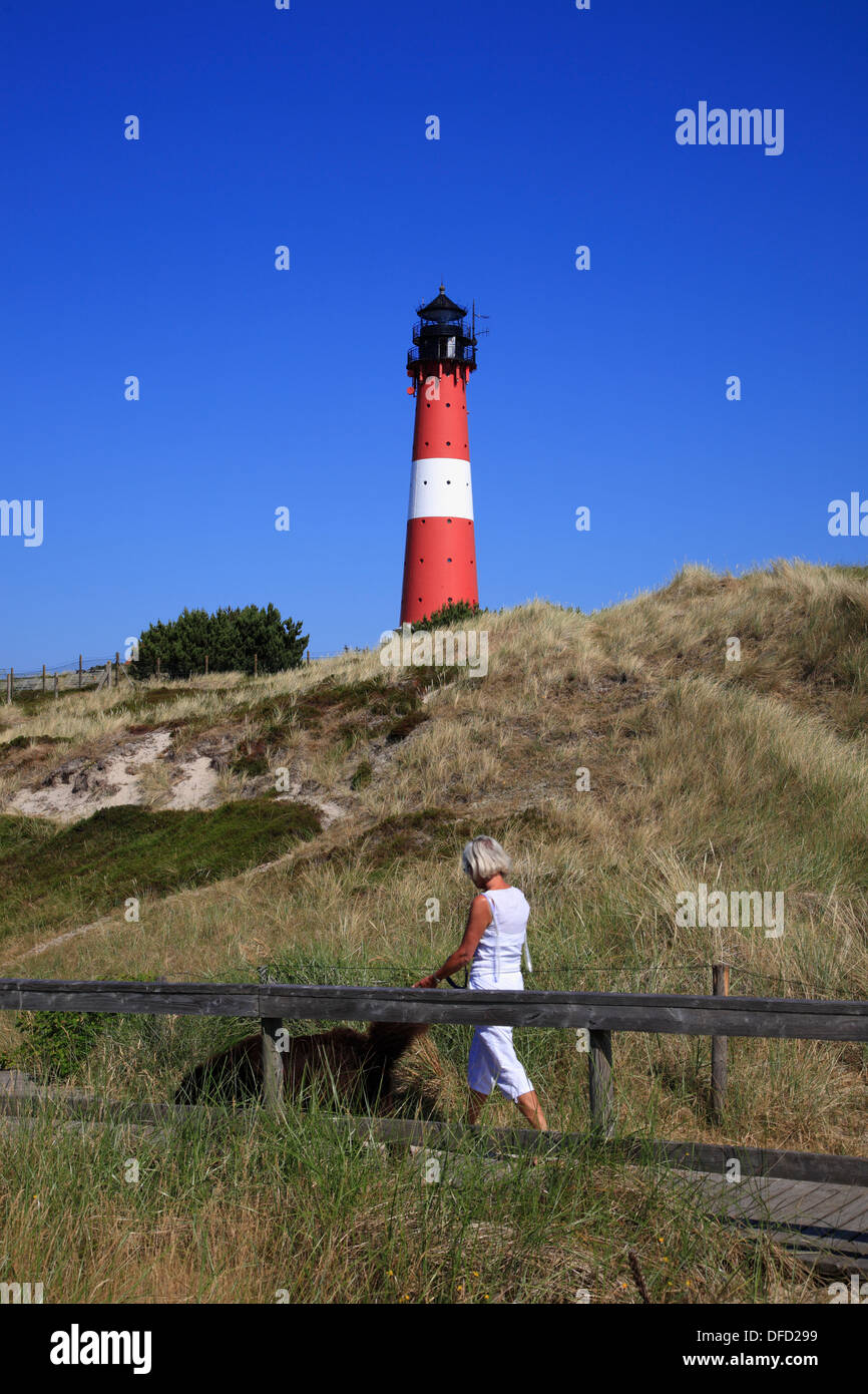 Hiker at Hoernum lighthouse, Sylt Island, Schleswig-Holstein, Germany ...
