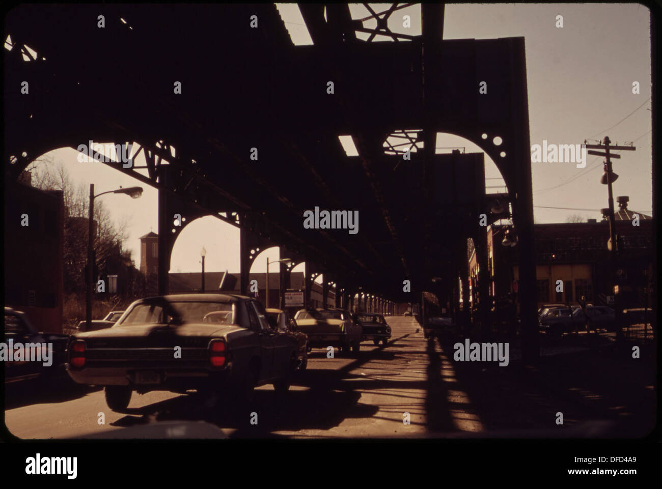 An elevated railroad structure spans over a blighted area near ...