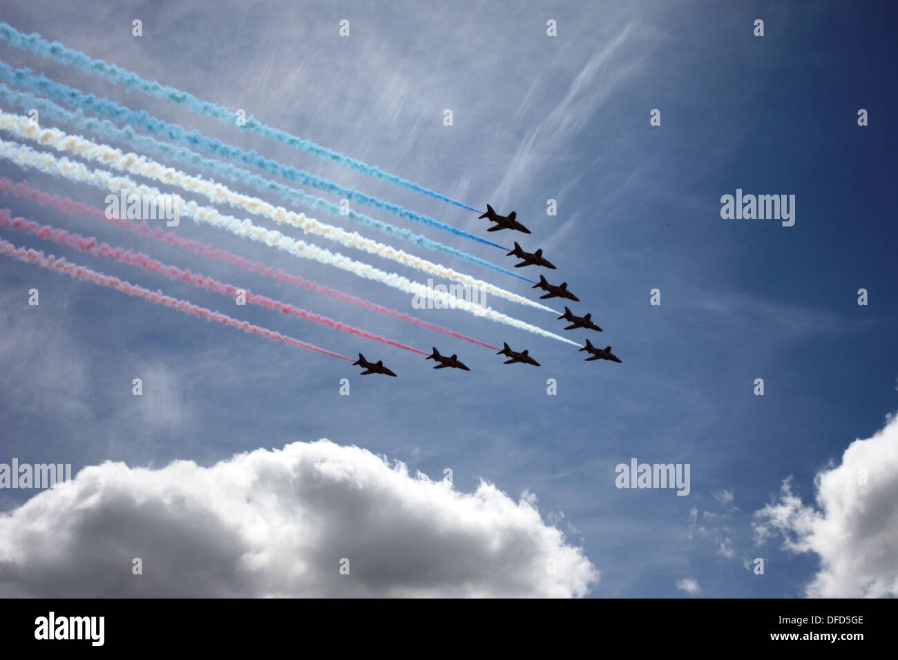 red arrows flying in formation with smoke in a cloudy blue sky Stock ...