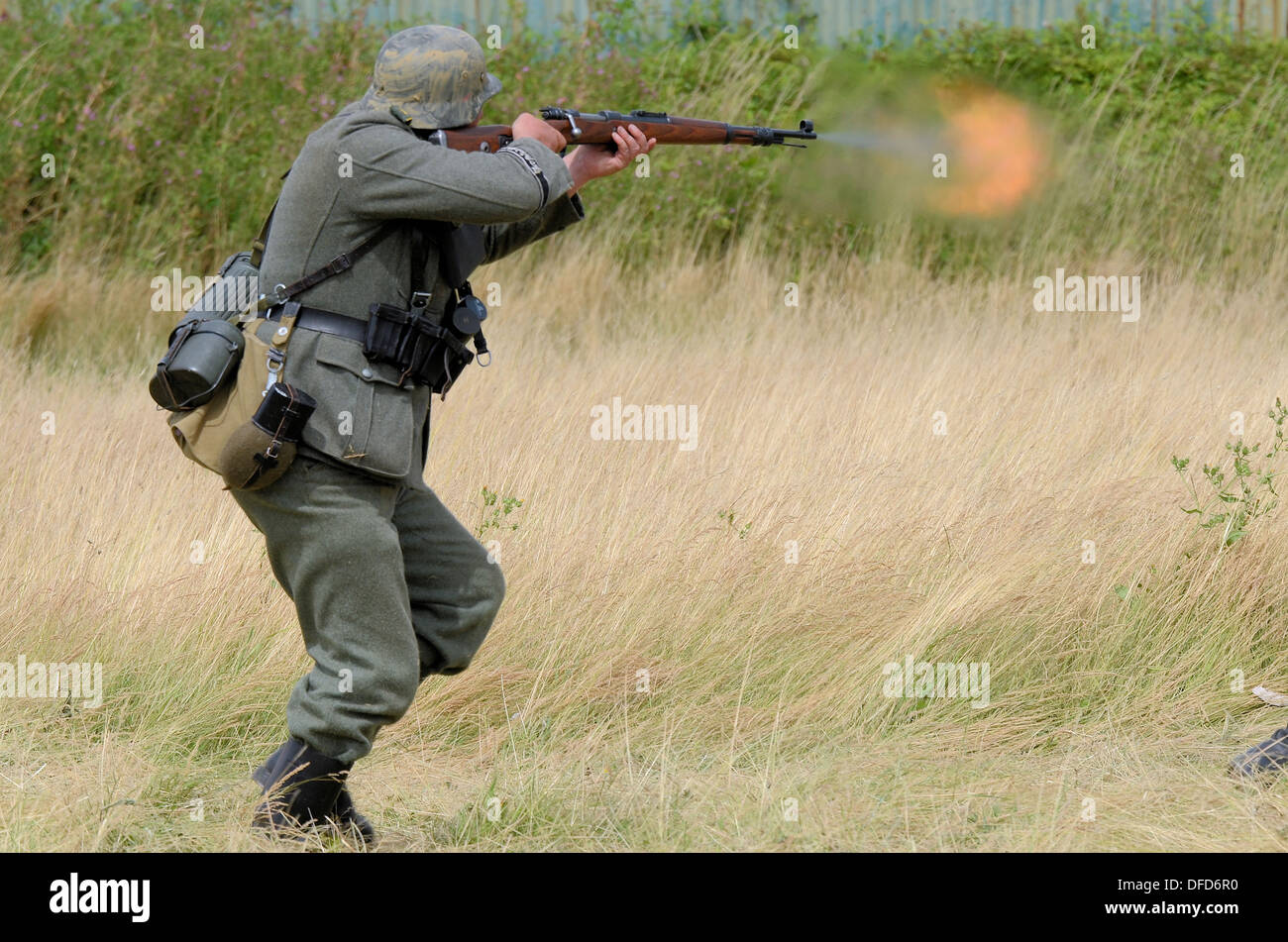 A World War II re-enactor in Second World War German army uniform fires ...