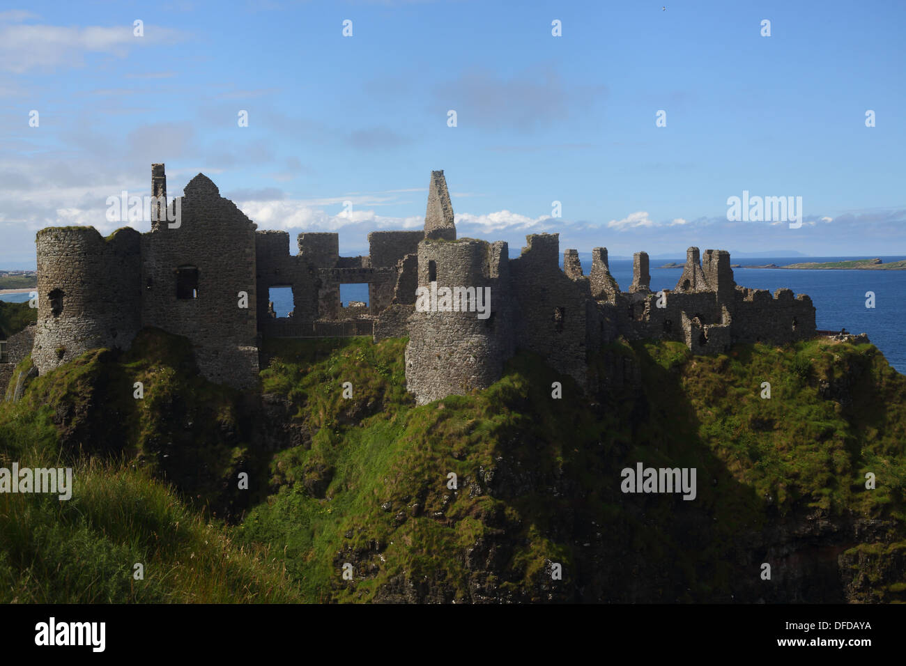 The ruins of Dunluce Castle atop a basalt cliff on the Causeway Coast ...
