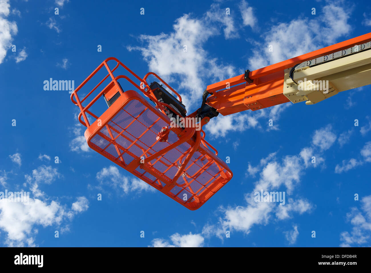 Orange hydraulic utility lift used in the construction industry shot ...