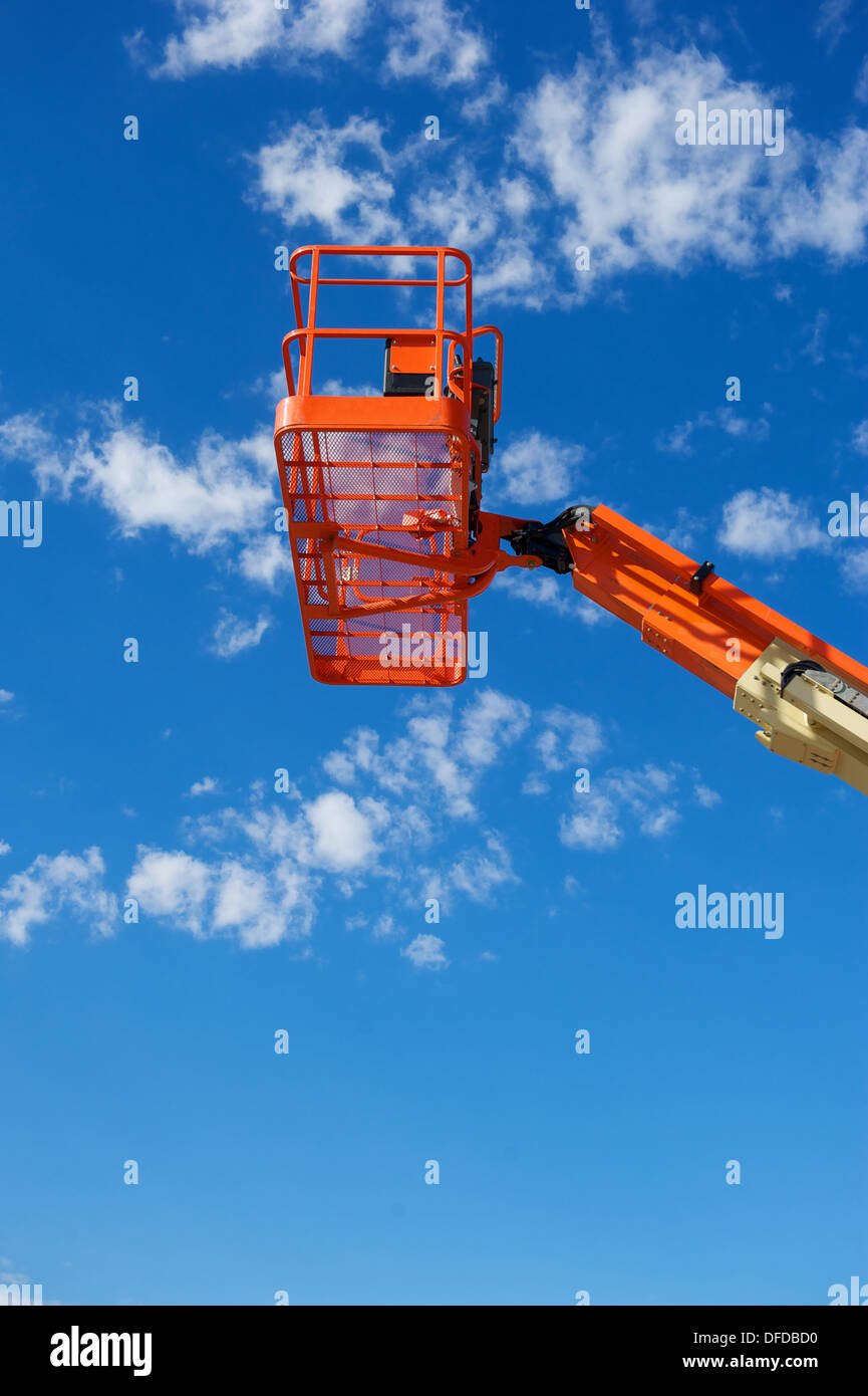 Orange hydraulic utility lift used in the construction industry shot ...