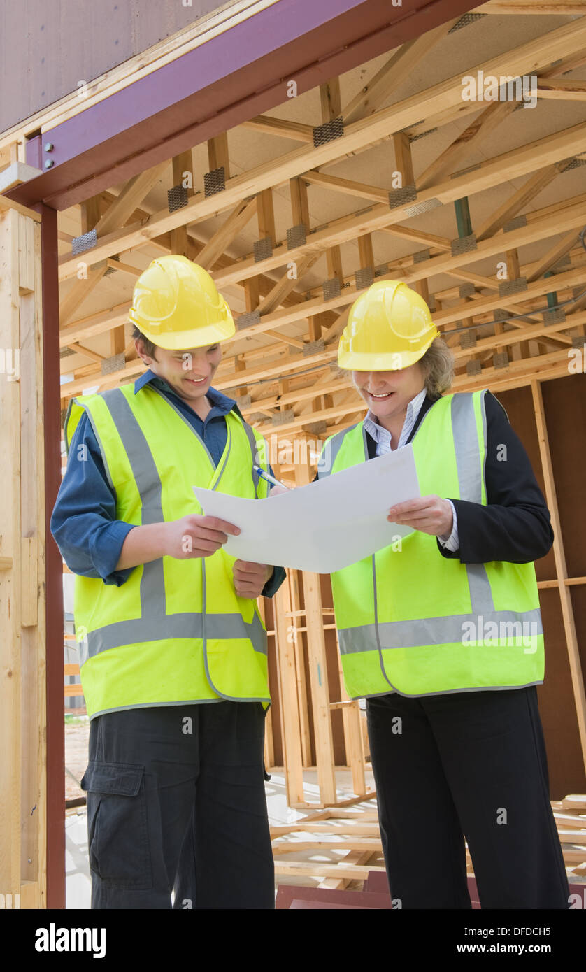 civil engineer and worker discussing issues at the construction site ...