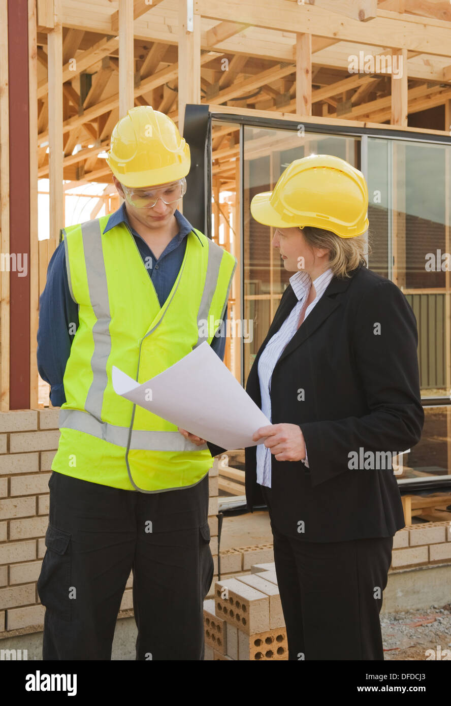 civil engineer and worker discussing issues at the construction site ...