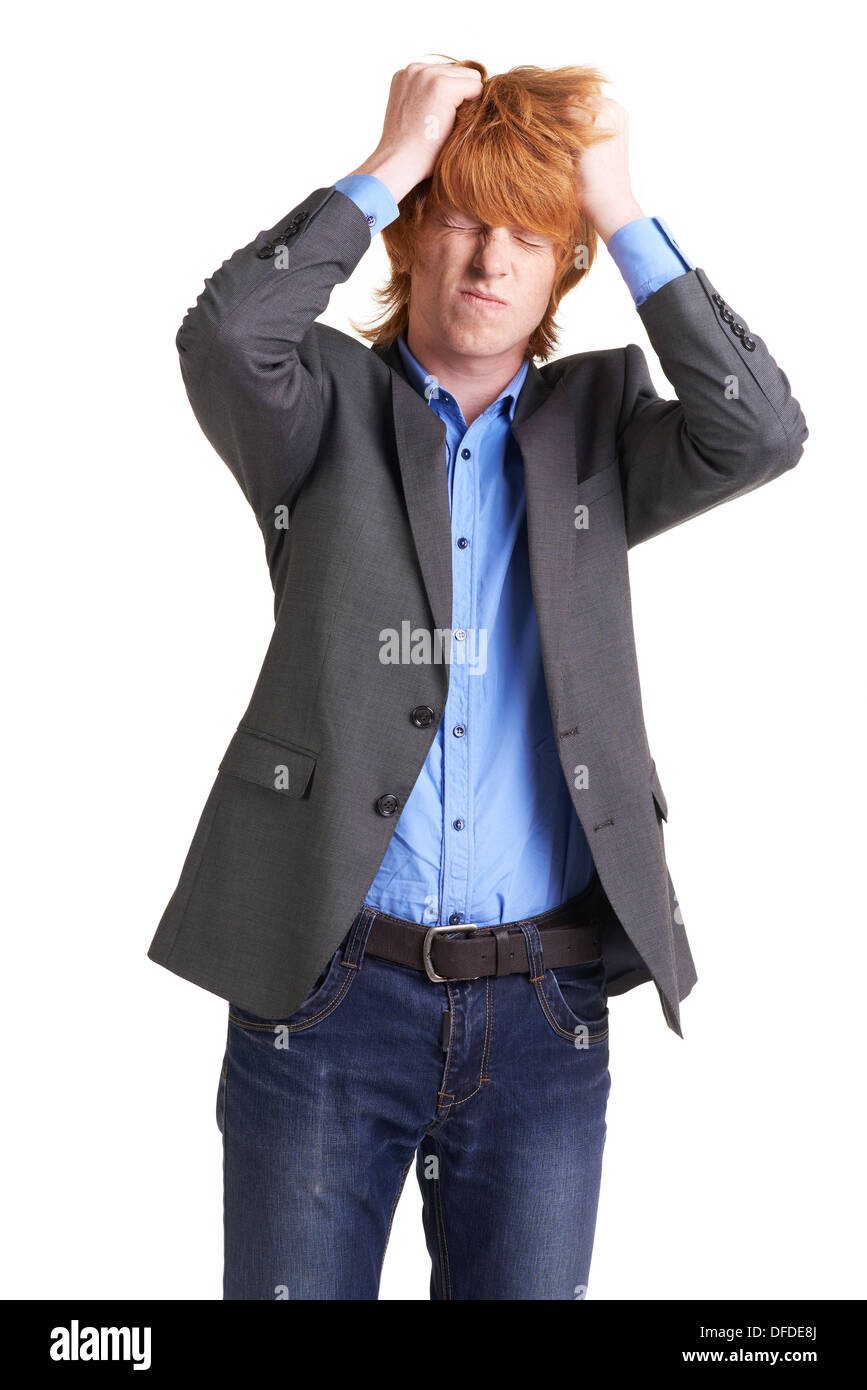 Portrait of young guy in smart clothes holding his head in isolation ...