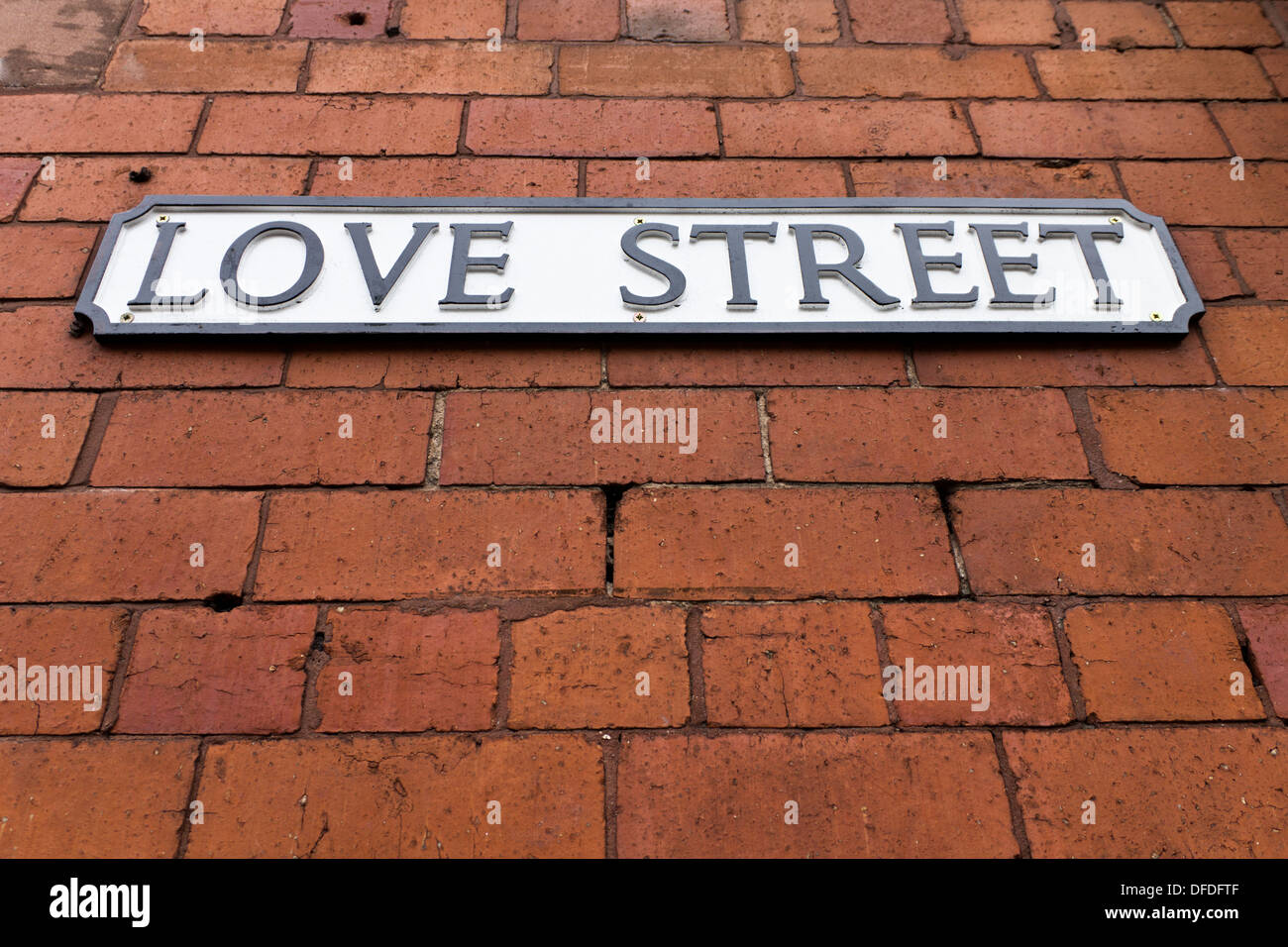 Love Street Sign on a red brick wall Stock Photo - Alamy