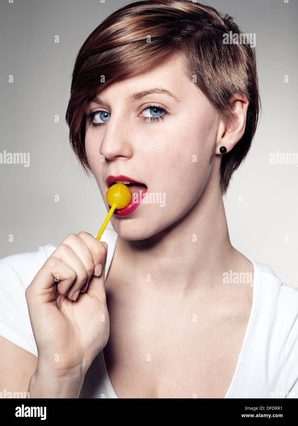 Portrait of Young woman holding lollipop, close up Stock Photo - Alamy