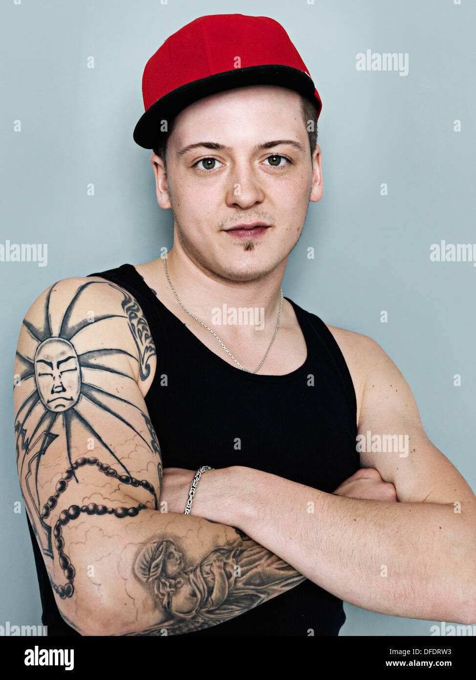 Portrait of young man with tattoos, smiling Stock Photo - Alamy