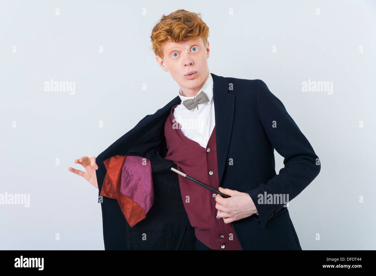 Portrait of young man holding magic wand Stock Photo - Alamy