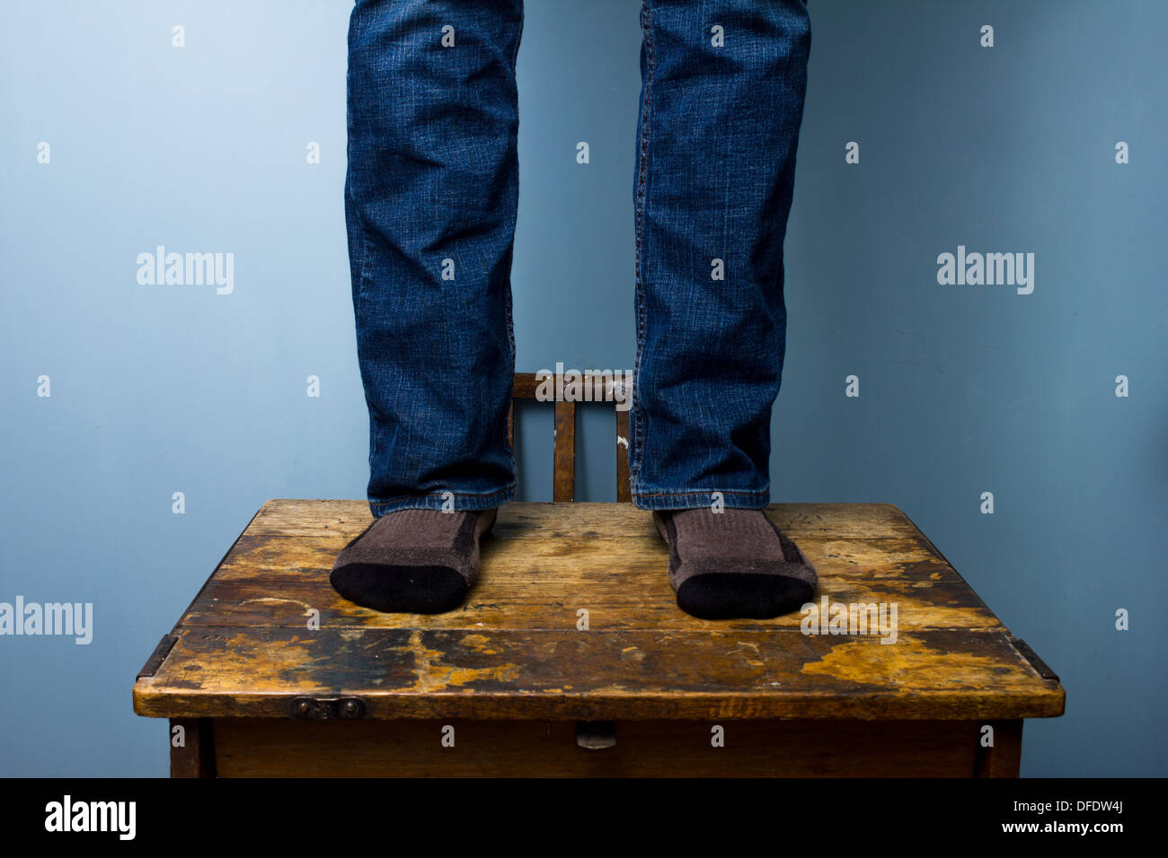 Man standing feet on chair hi-res stock photography and images - Alamy
