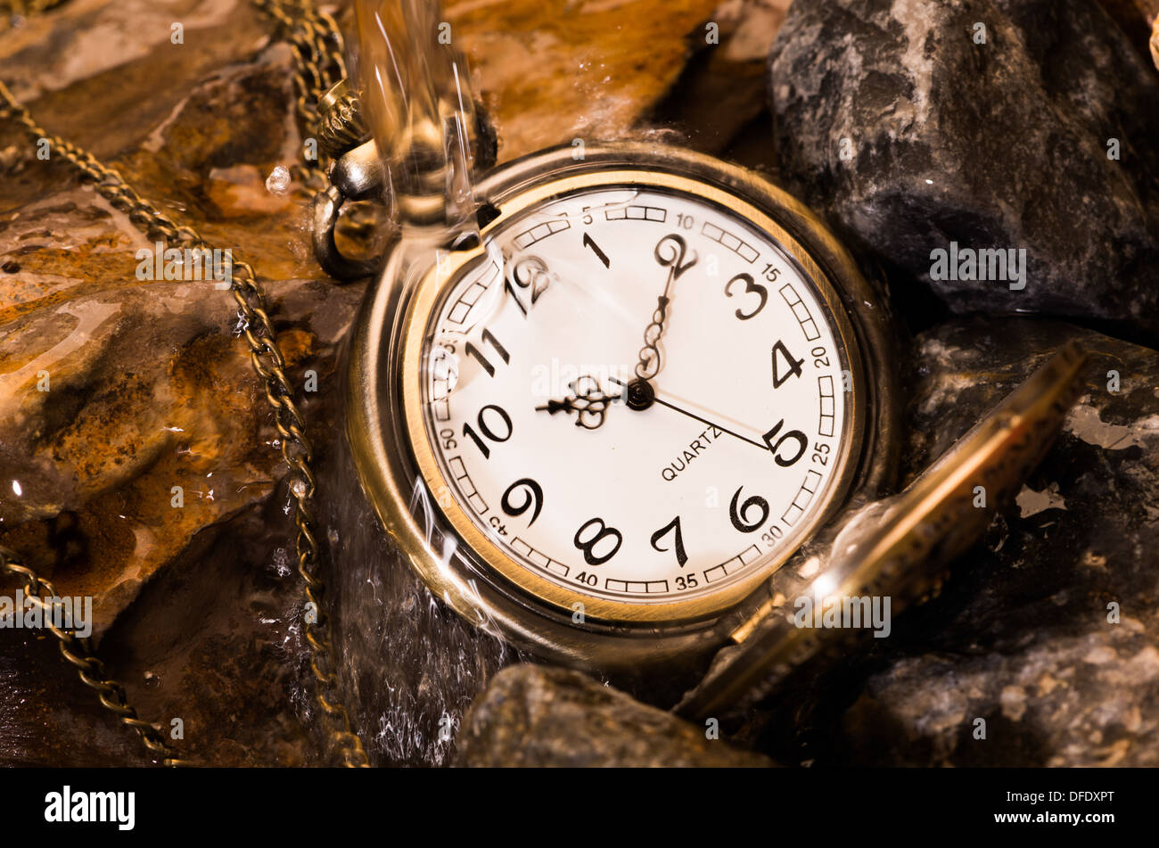 pocket watch with rock Stock Photo - Alamy