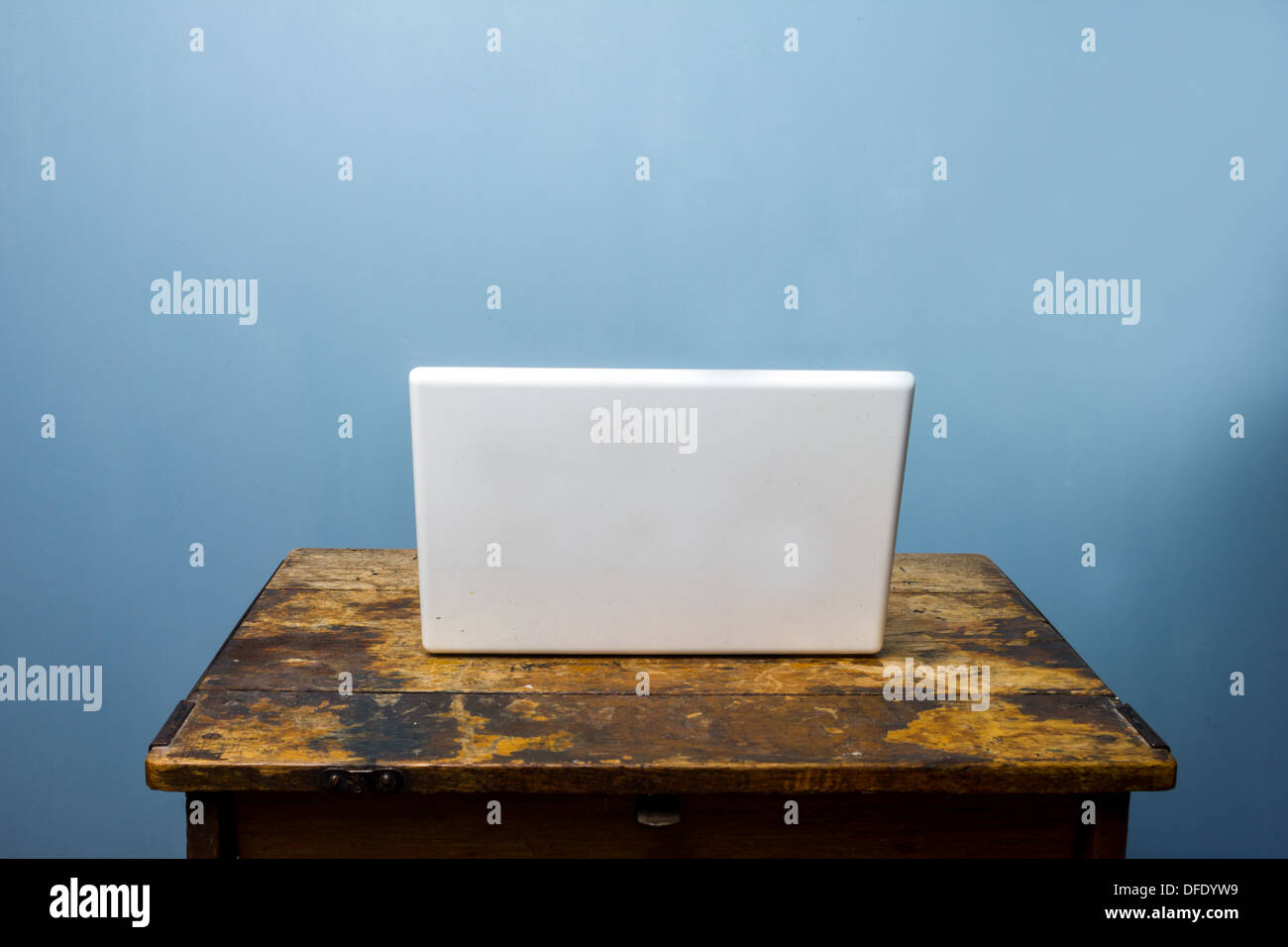 White laptop on an old desk Stock Photo - Alamy