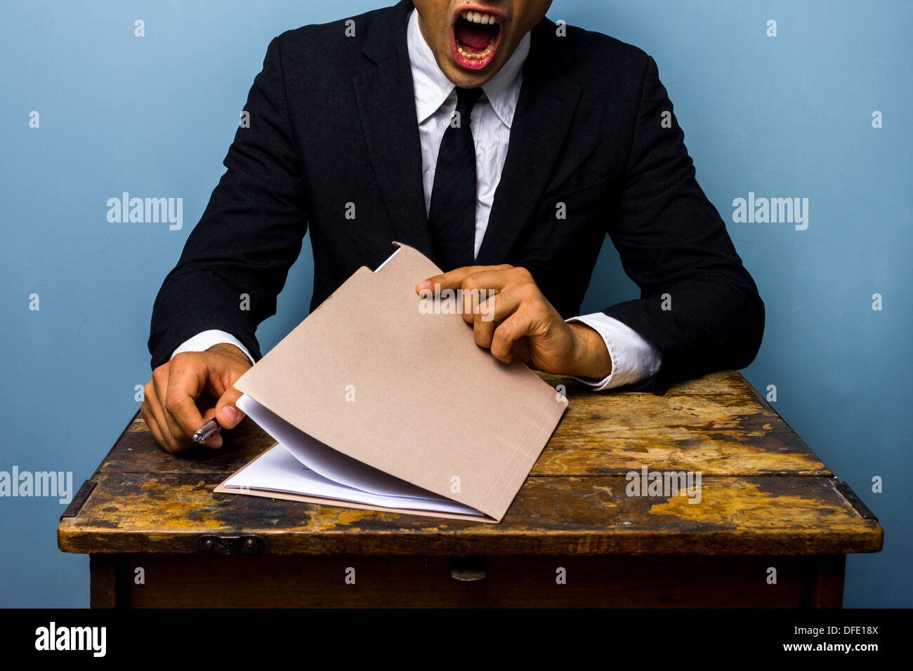 Tired businessman is looking over important documents Stock Photo - Alamy