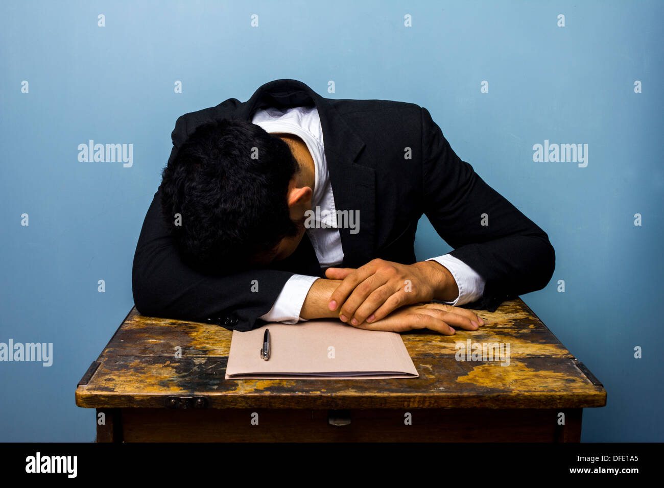 Businessman is sleeping at desk after signing contract Stock Photo - Alamy