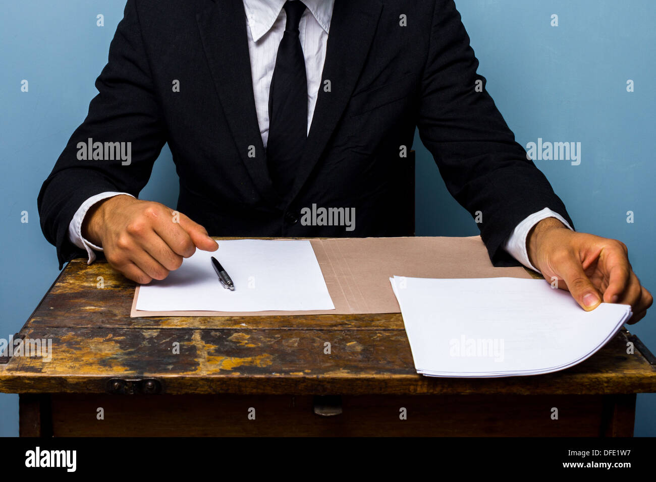 Businessman is looking over a contract he is about to sign Stock Photo ...