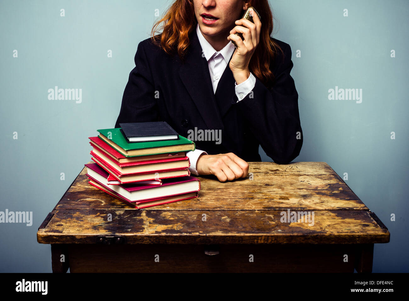 Woman sitting on stack books hi-res stock photography and images - Alamy