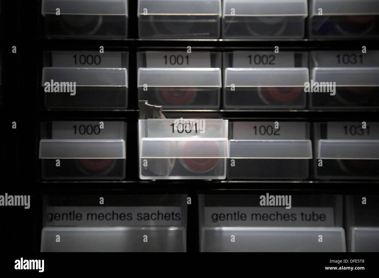 Plastic storage drawers containing tubes of hair colours Stock Photo ...
