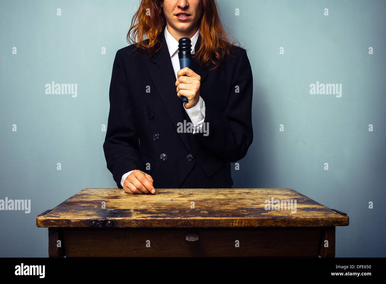 Woman speaking into microphone hi-res stock photography and images - Alamy