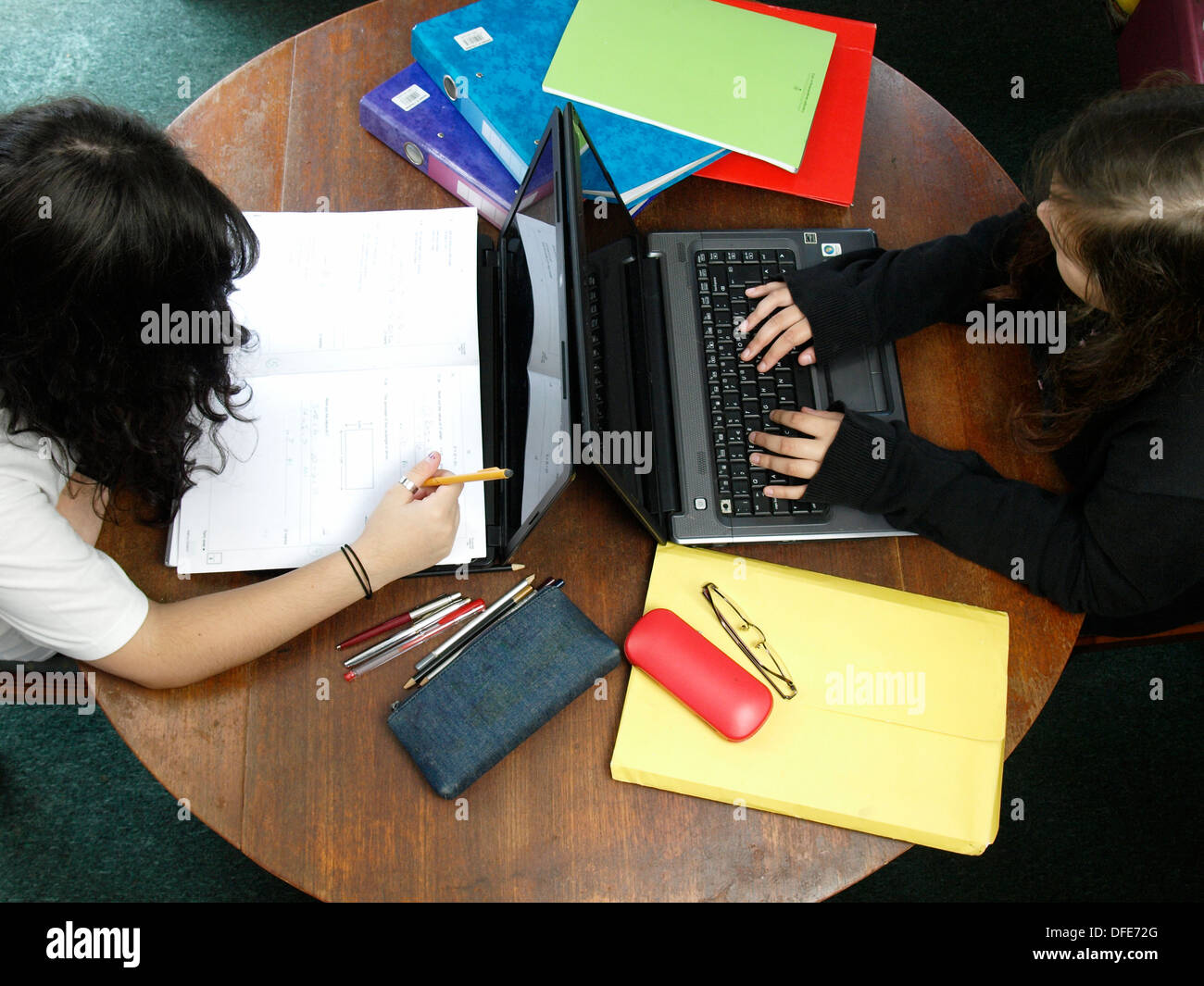 Two teenage girls doing homework after school, UK Stock Photo - Alamy