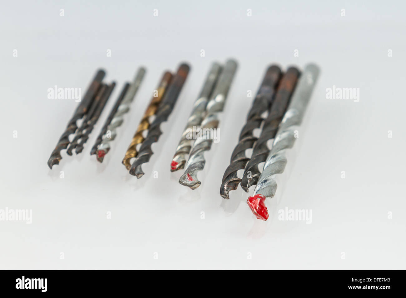 Assorted drill bits on isolated white background Stock Photo - Alamy