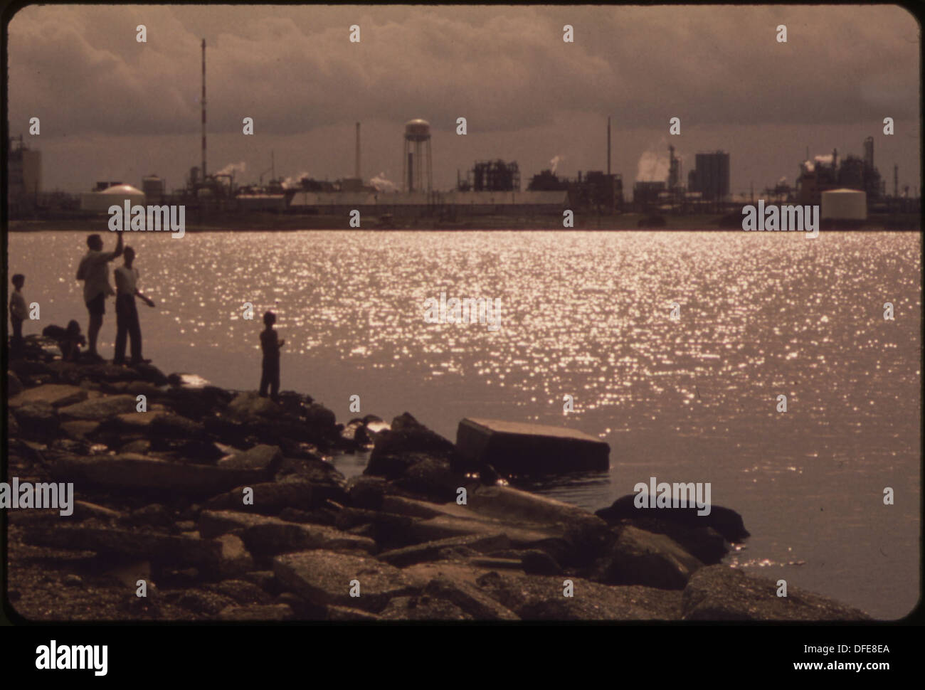 The scene captures fishermen fishing at sunset in the Houston Ship ...