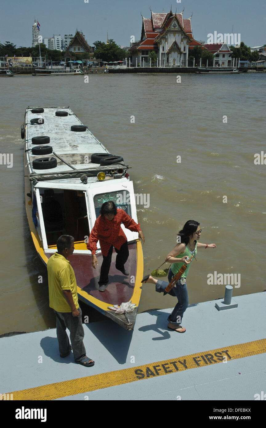 Women deboarding a river taxi Bangkok, Thailand Stock Photo - Alamy