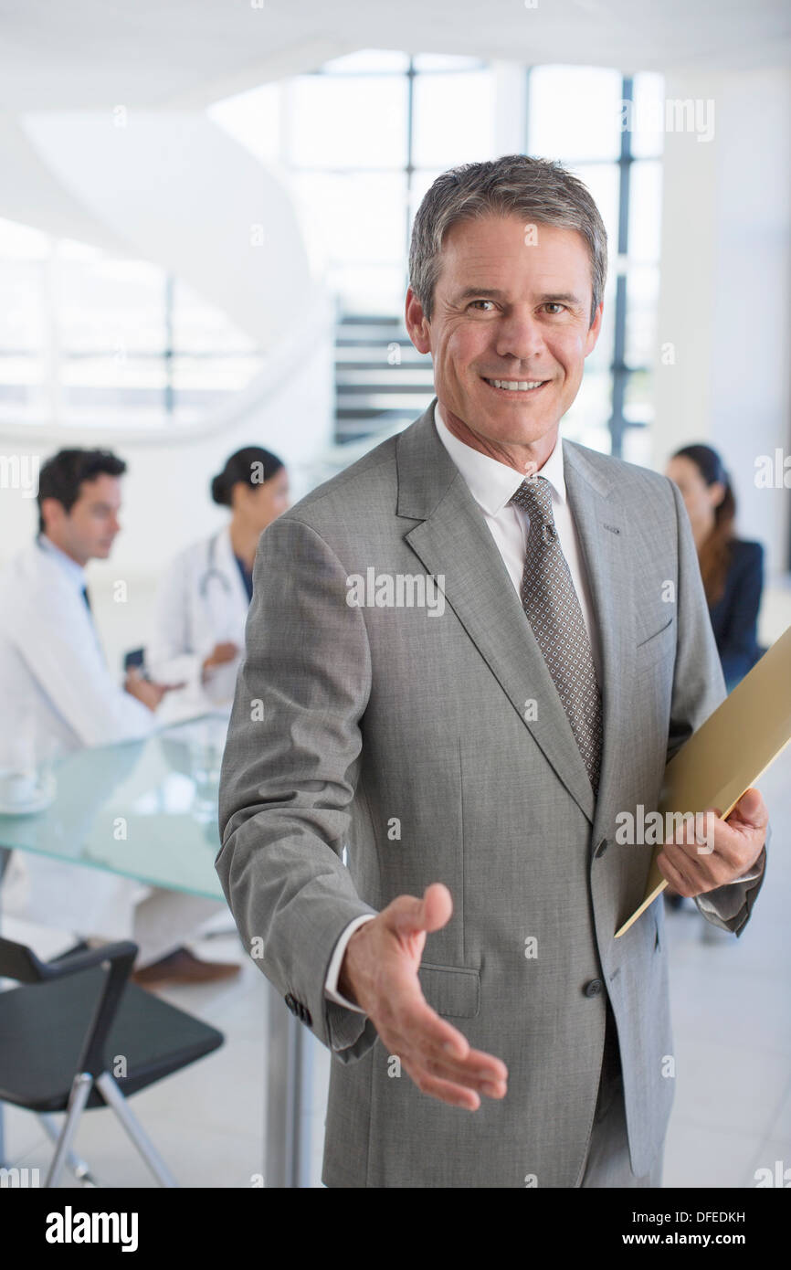 Businessman offering handshake in meeting Stock Photo - Alamy