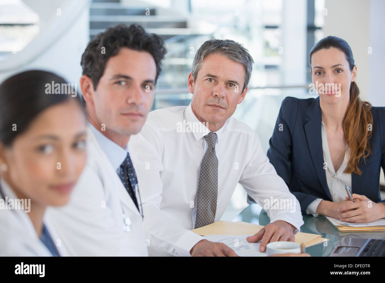 Portrait of doctors and business people in meeting Stock Photo - Alamy