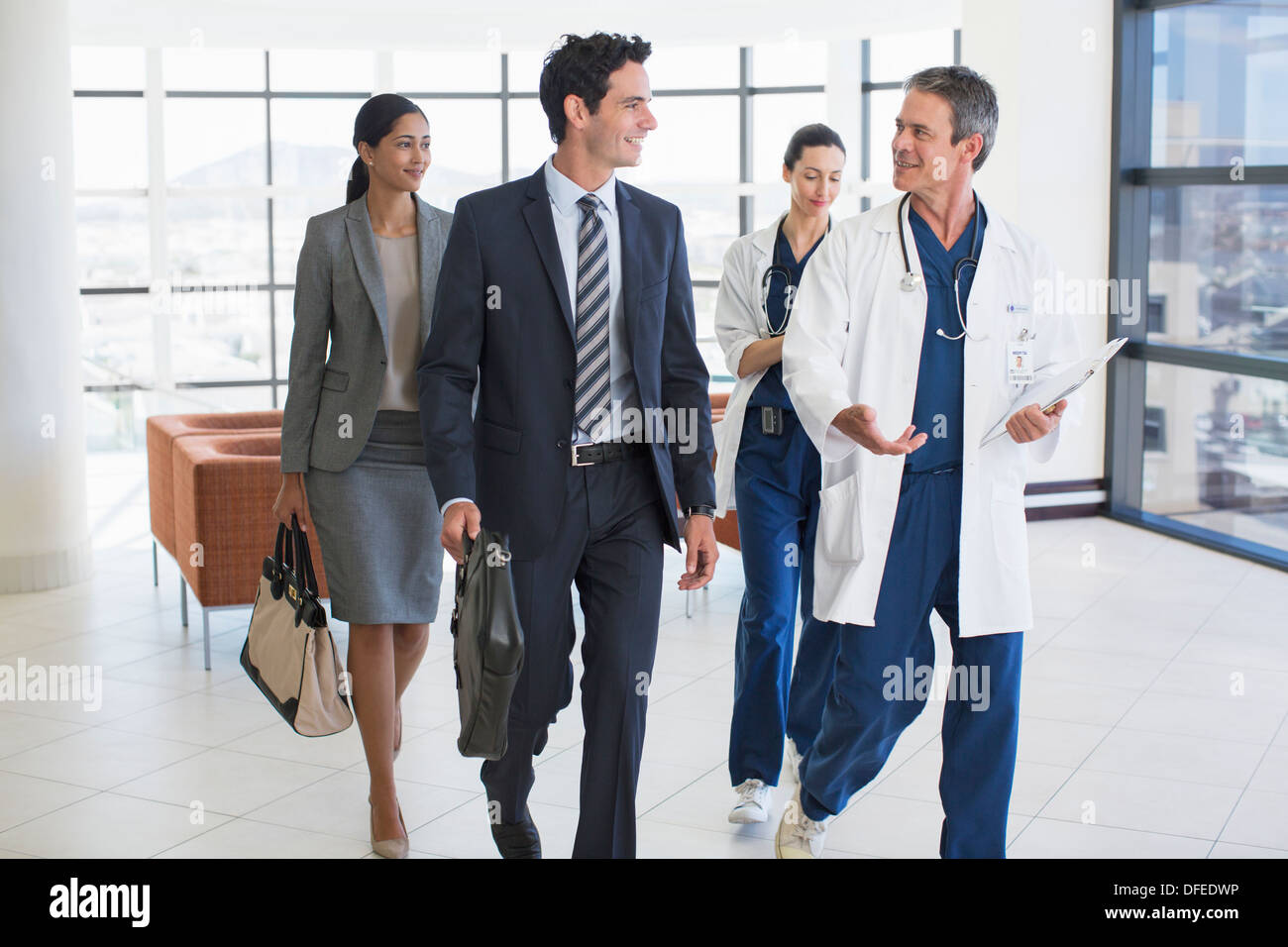 Doctors and business people talking in hospital Stock Photo - Alamy