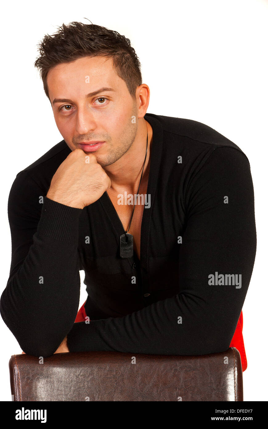 Modern guy posing with hand on a seat chair isolated on white ...