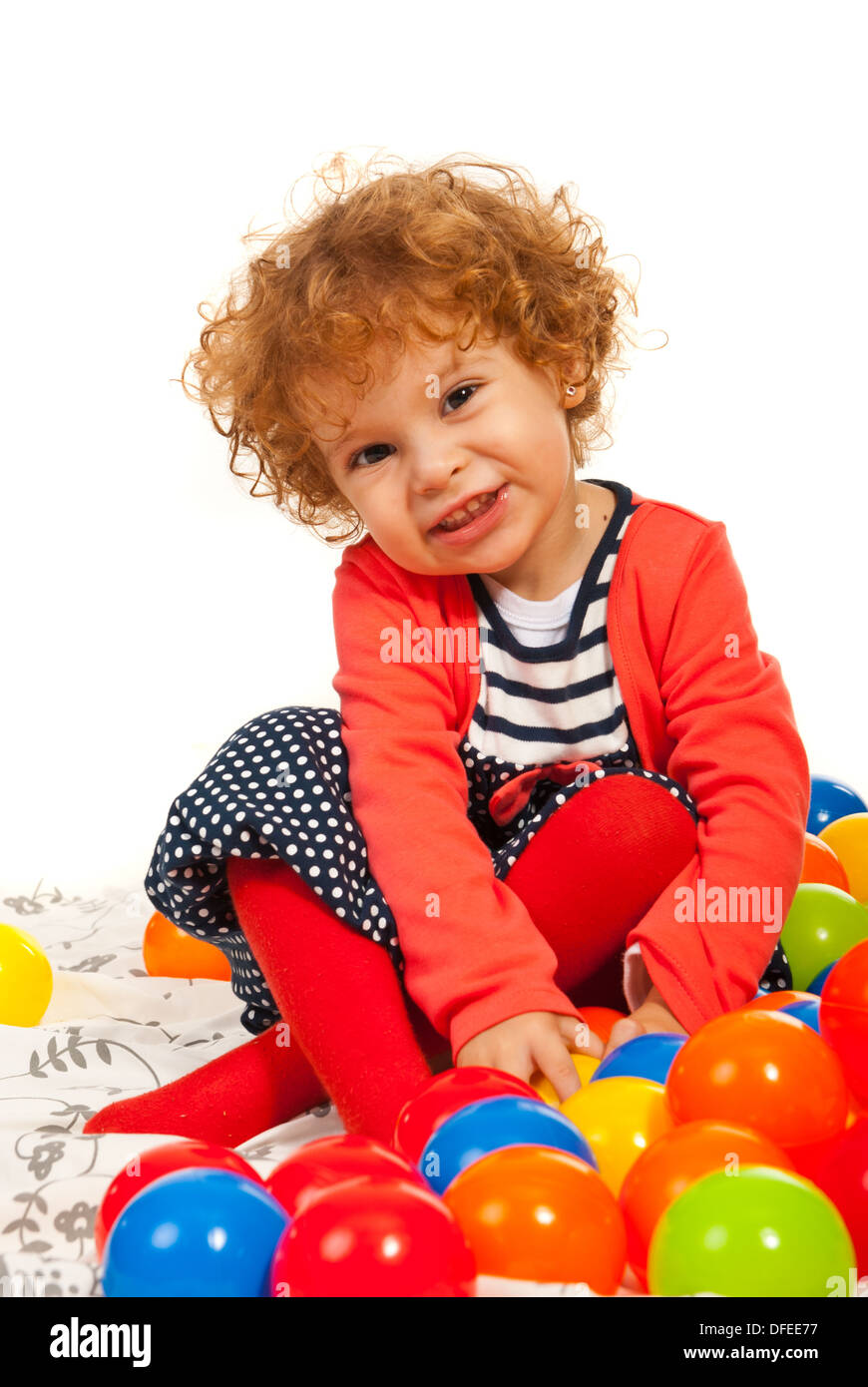 Happy toddler girl with colorful balls against white background Stock ...