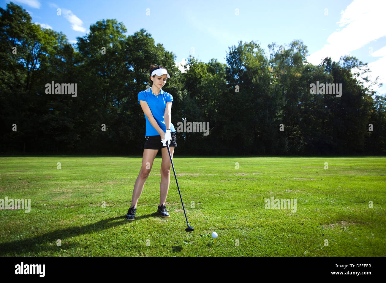 Girl playing golf Stock Photo - Alamy