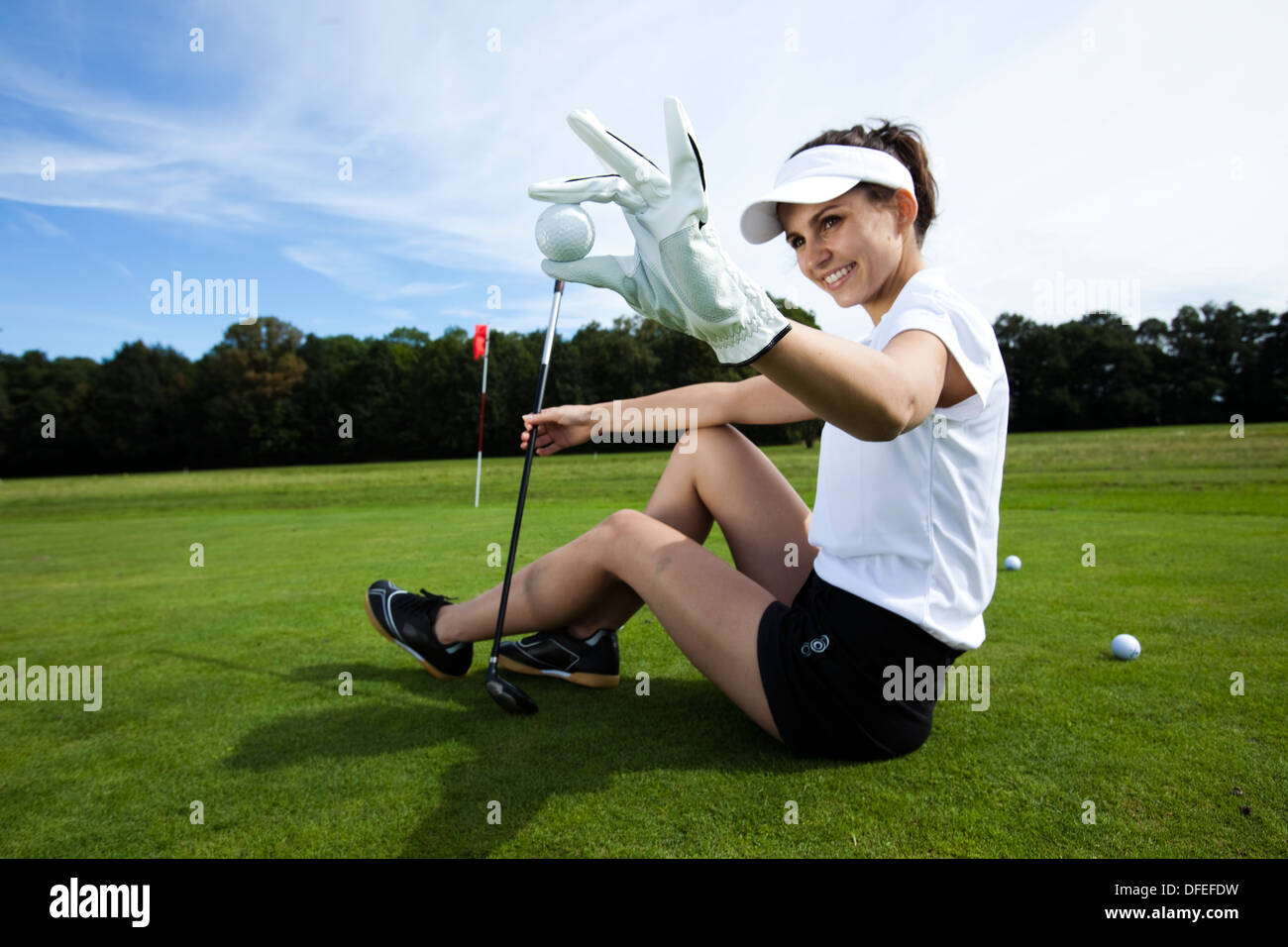 Girl playing golf Stock Photo - Alamy
