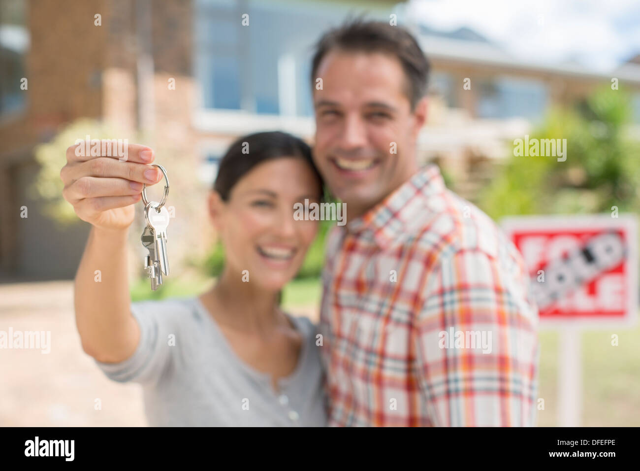 Portrait of smiling couple holding house keys Stock Photo - Alamy