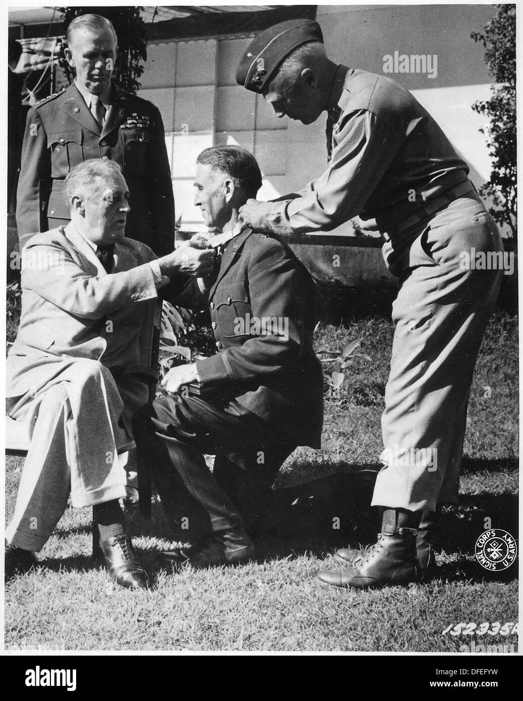 A historical photograph shows Franklin D. Roosevelt with military ...