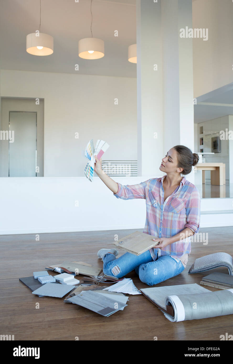 Woman viewing paint swatches in new house Stock Photo - Alamy