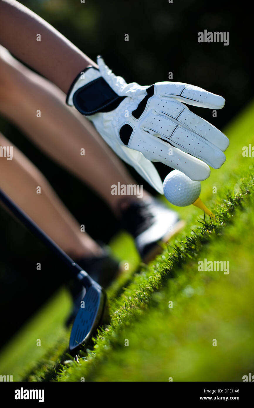 Playing golf, ball on tee Stock Photo - Alamy