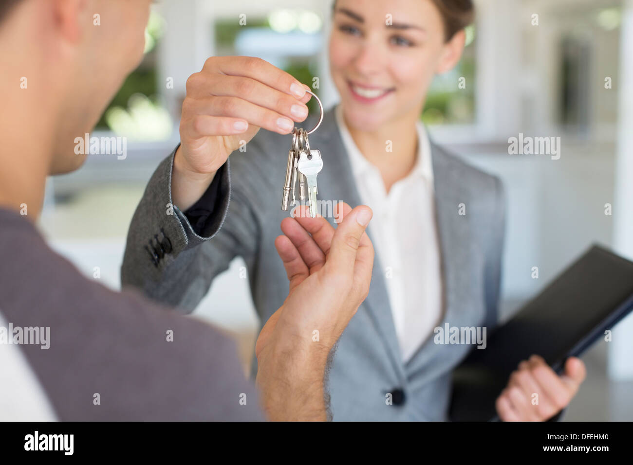 Realtor giving man house keys Stock Photo - Alamy
