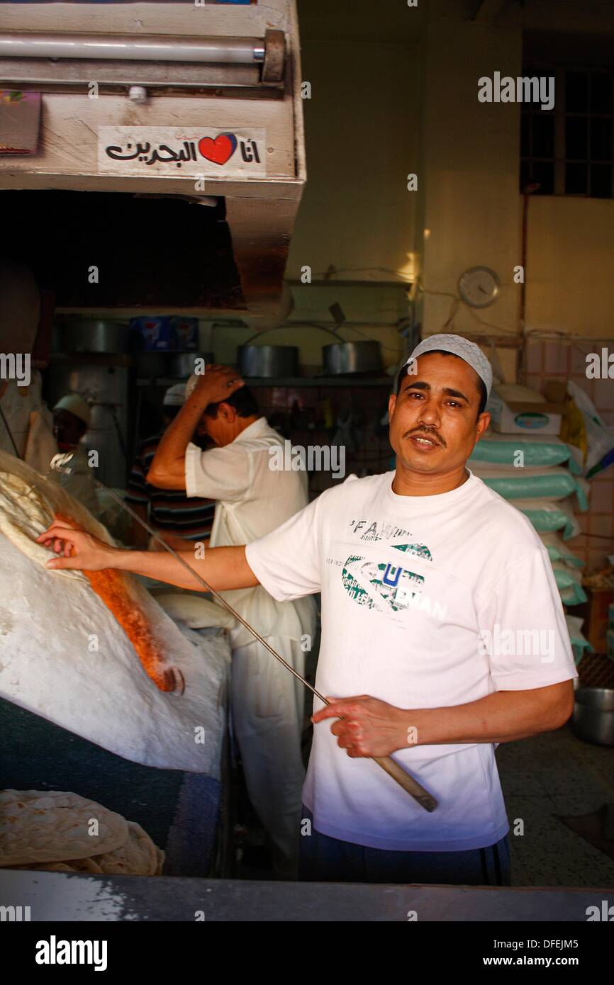 A nepali baker making bread from Muharraq Island, Bahrein Stock Photo ...