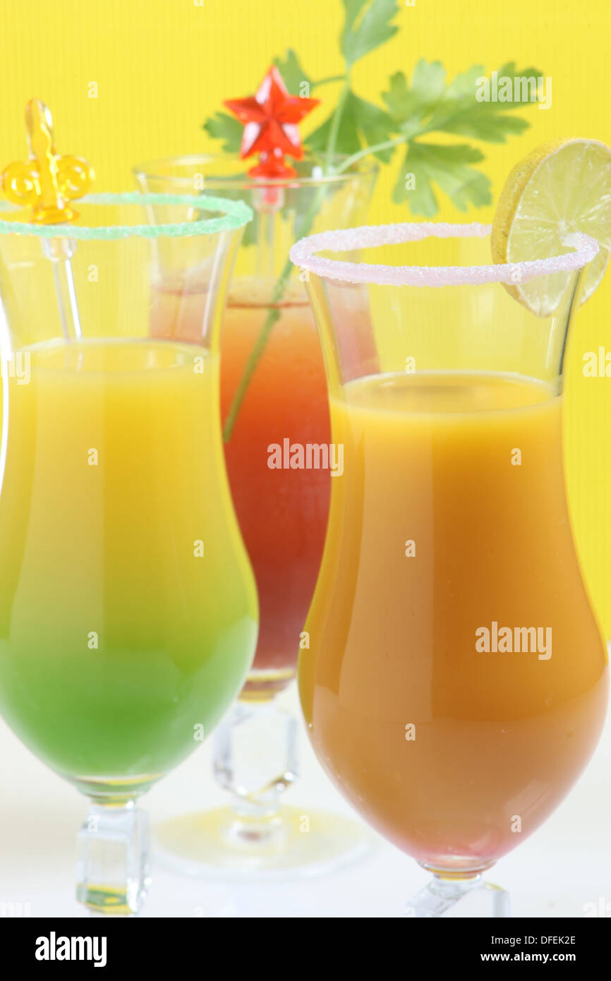 Three cocktails with yellow background Stock Photo - Alamy