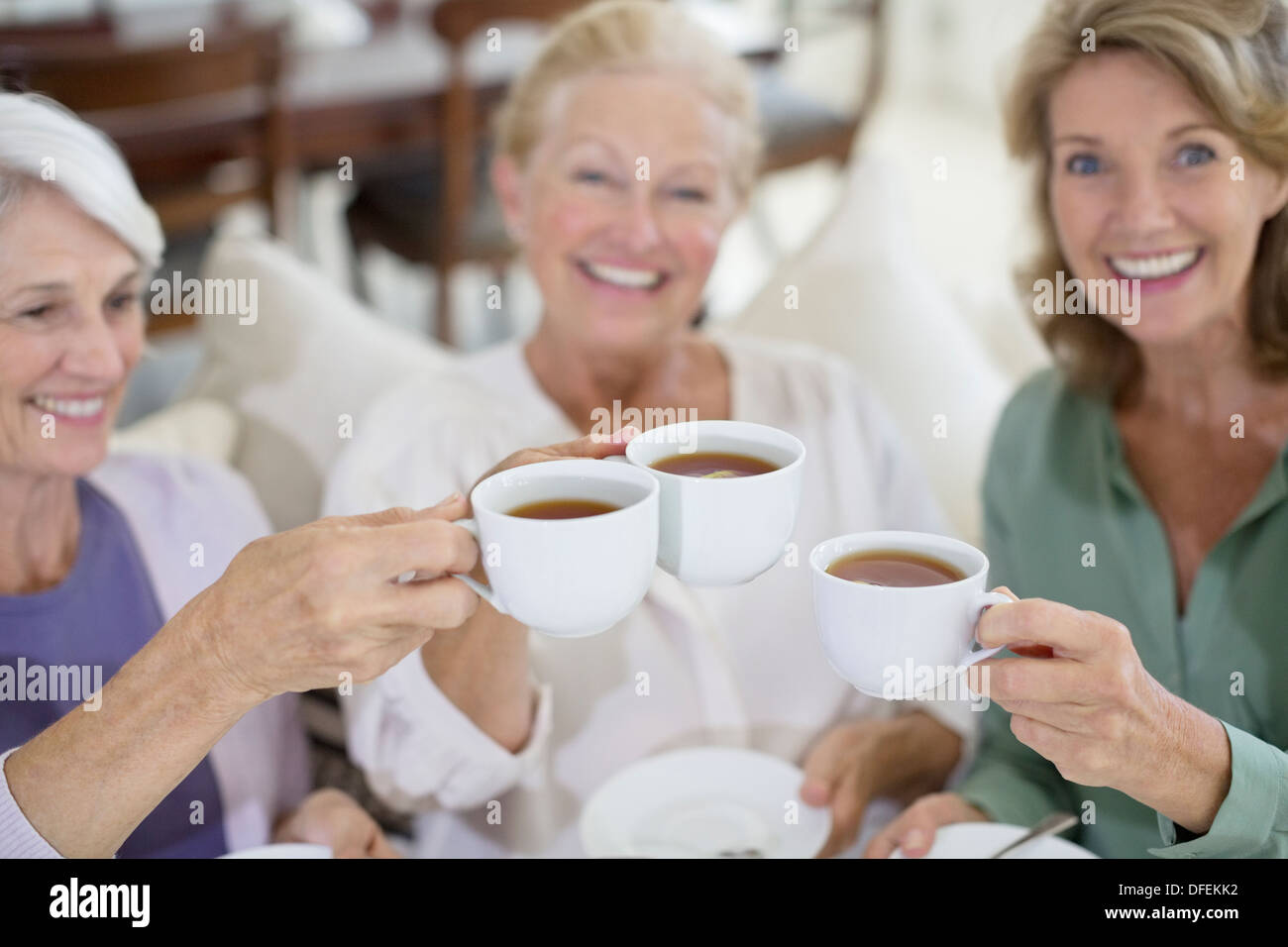 Senior women toasting coffee cups Stock Photo - Alamy