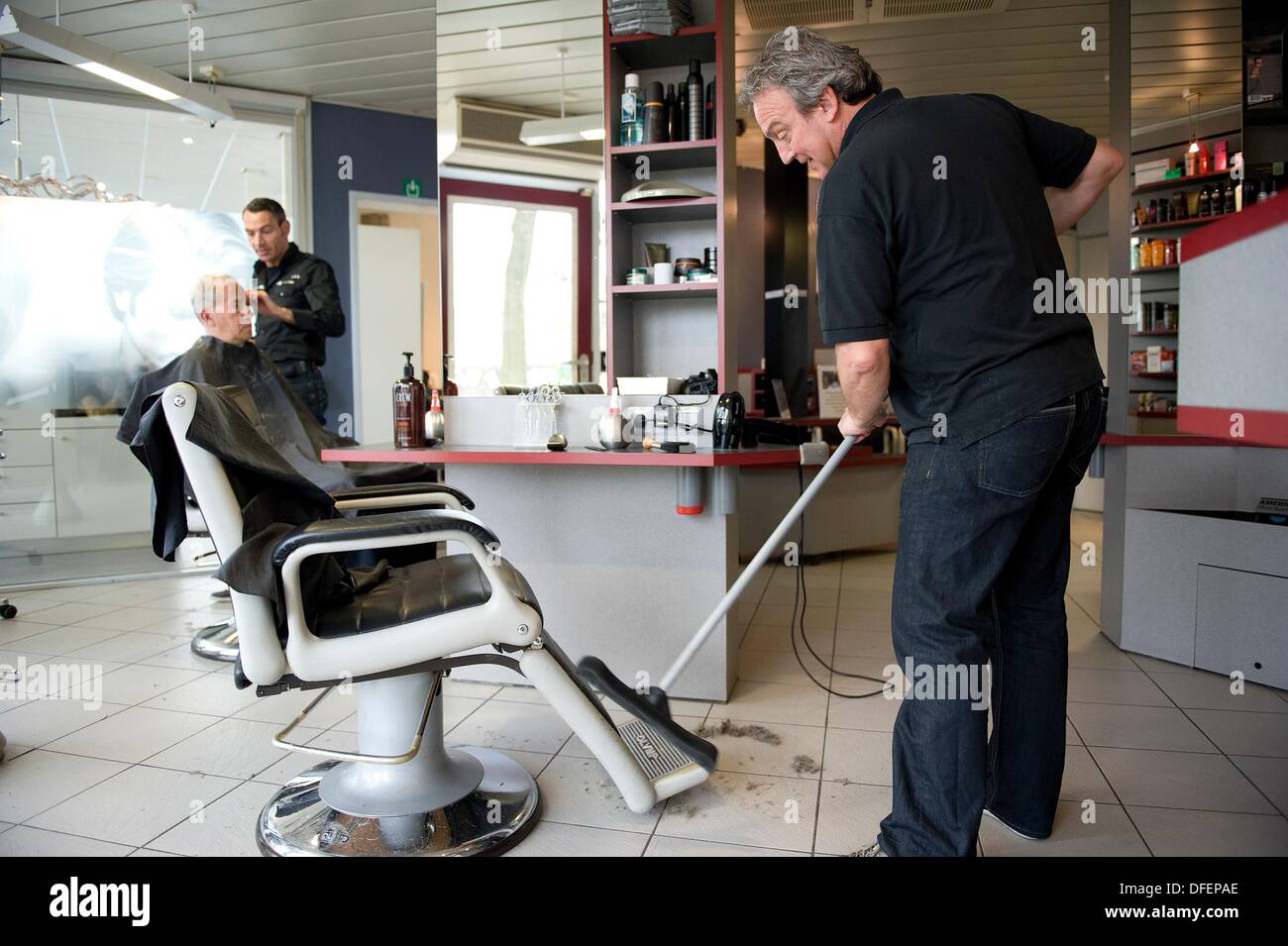 Barber cleaning floor hairdresser salon hi-res stock photography and ...
