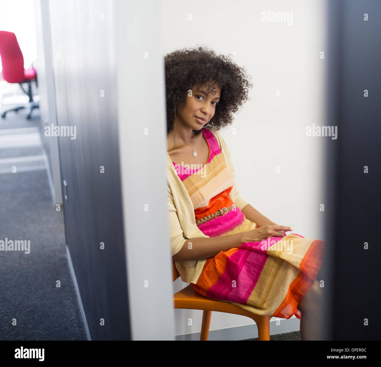 Smiling female executive sitting in hi-res stock photography and images ...