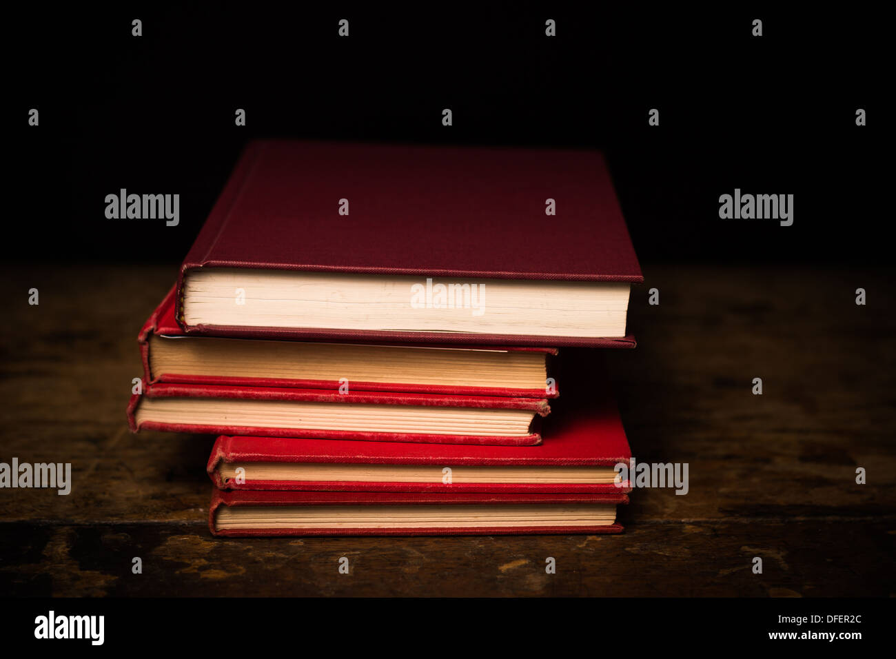 Stack of red books on wood surface Stock Photo - Alamy